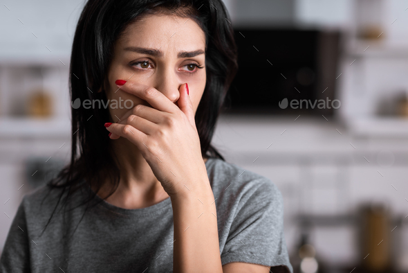 sad and injured woman with bruise covering face, domestic violence ...