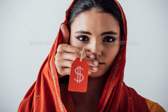 Male hand holding price tag with dollar sign near face of crying indian ...