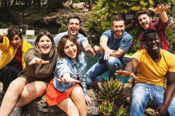 Joyful multiethnic diverse group of young people having fun together ...