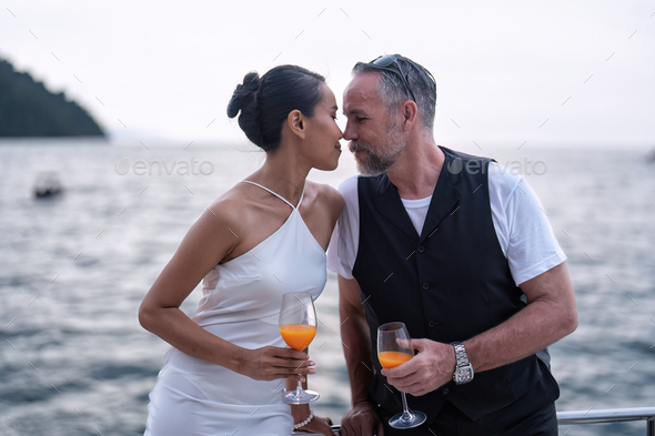 Romantic couple in love have fun sailing in the sea standing on yacht ...