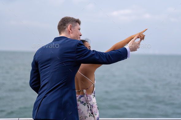 Romantic couple in love have fun sailing in the sea standing on yacht ...