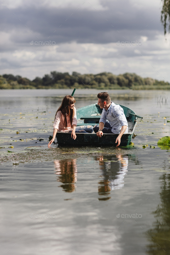 Just relaxing. Beautiful young couple enjoying romantic date while ...