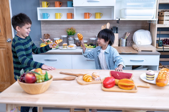 Children in learning kitchen room playing use fake bread and wooden ...