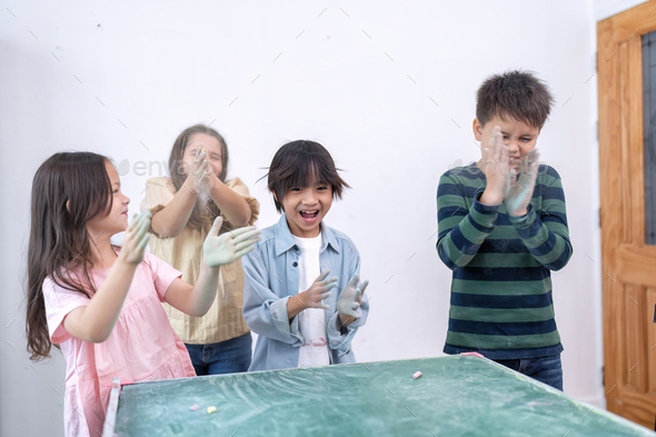 Children in class room happy laughing enjoy chalk drawing on green ...
