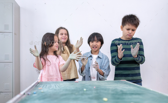 Children in class room happy laughing enjoy chalk drawing on green ...