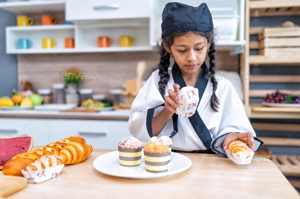 Children in learning kitchen room playing made loaf of bread put on the ...