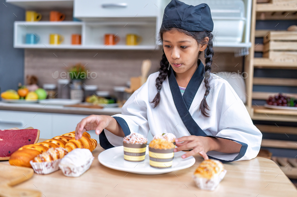 Children in learning kitchen room playing made loaf of bread put on the ...