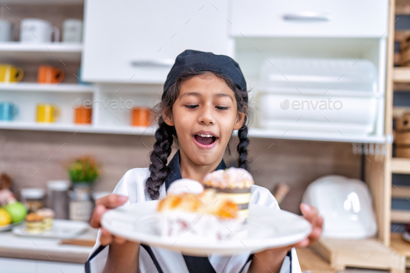 Children in learning kitchen room playing made loaf of bread put on the ...