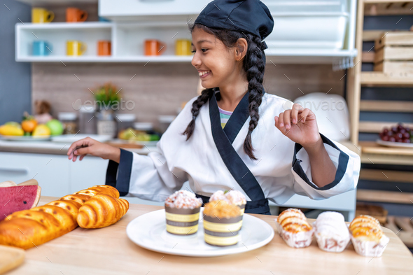 Children in learning kitchen room playing made loaf of bread put on the ...
