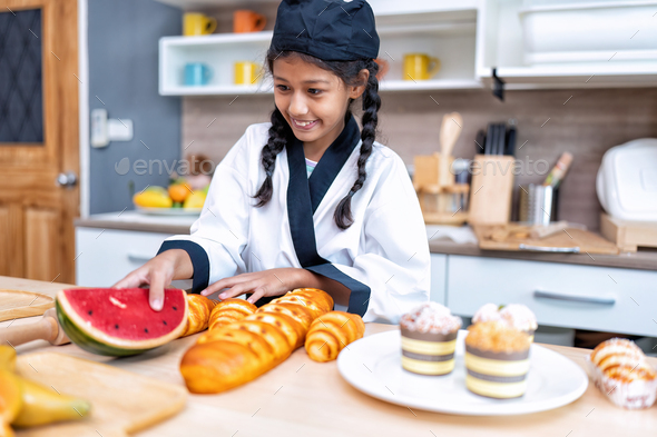 Children in learning kitchen room playing made loaf of bread put on the ...