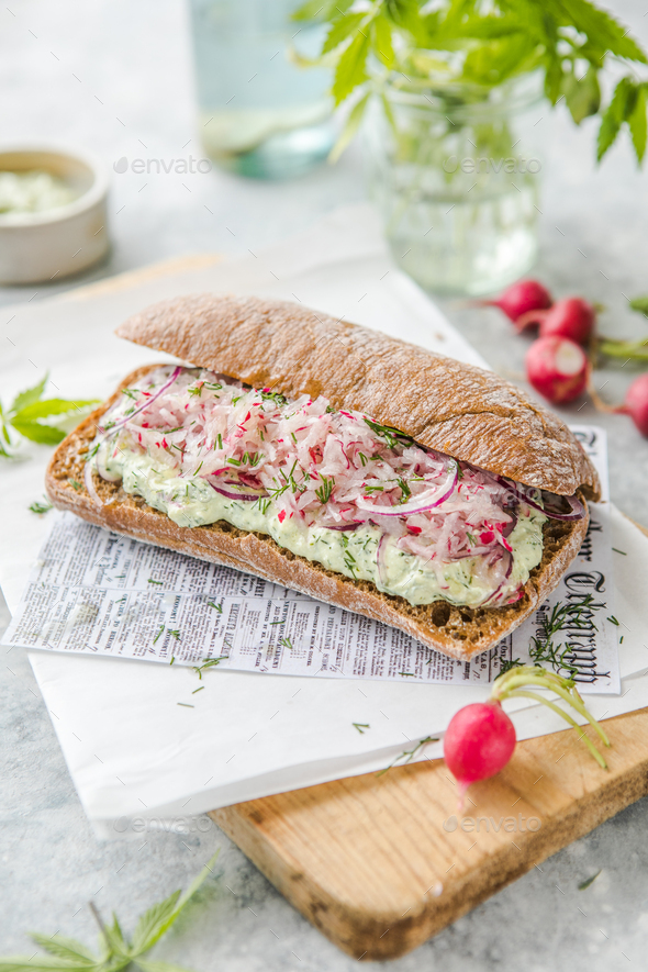 Fresh green spring sandwich with cream cheese and radish at light ...