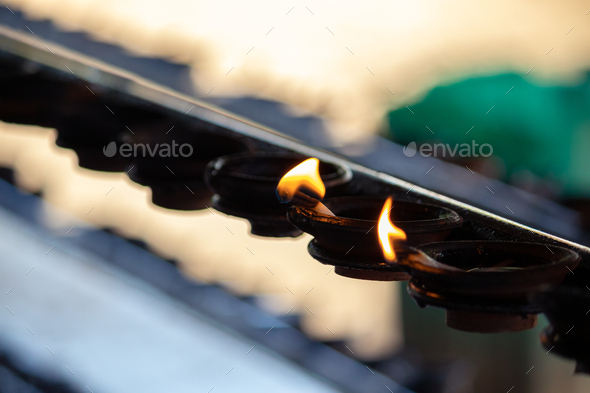 Burning clay oil lamps, glowing with the wind in the dark, offering ...
