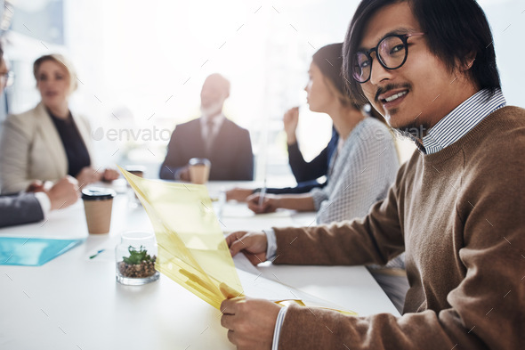 Working alongside his dedicated colleagues Stock Photo by ...