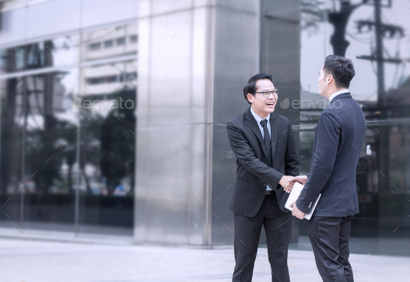 team of business people shake hands and stand talking and discussing in ...