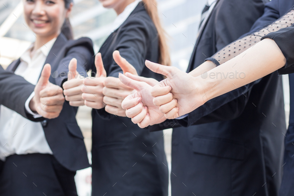 Compliment of teamwork, businesspeople show thumb to praise and great ...