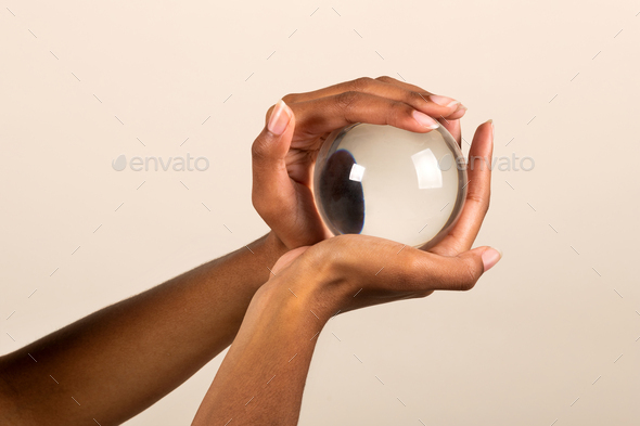 Crop black woman holding transparent glass sphere Stock Photo by ...