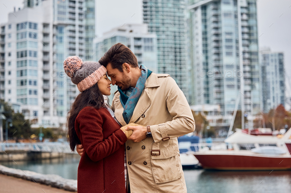Affectionate couple in love standing face to face on city quay. Stock ...