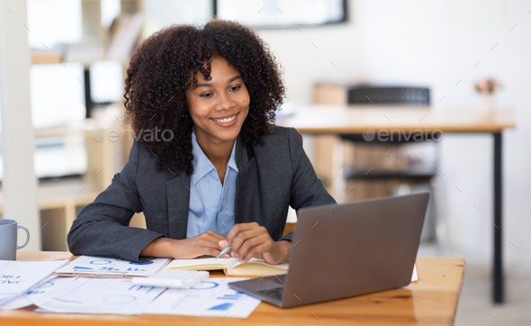 Portrait young african american girl woman working on laptop computer ...