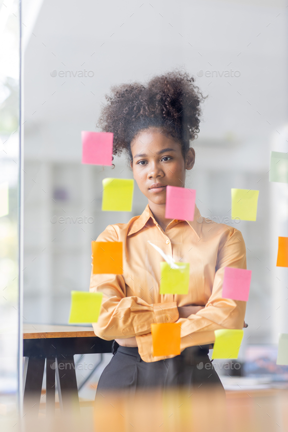 Young Serious african american Creative team use post it notes to share ...