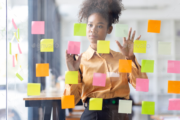 Young Serious african american Creative team use post it notes to share ...