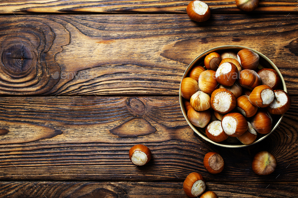 Hazelnuts on wooden backdrop. heap or stack of hazelnuts. Hazelnut ...