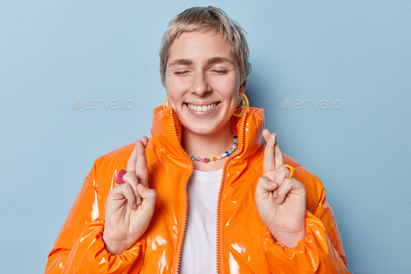 Cute hopeful woman has short hair smiles toothily has big hope in ...