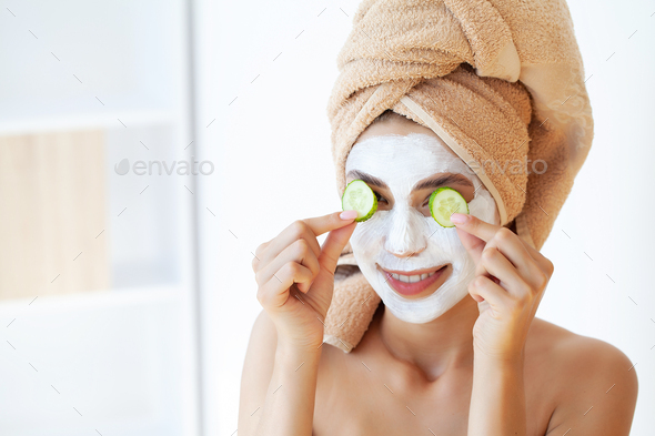 Skin care, woman with beautiful facial skin applying mask on face Stock ...
