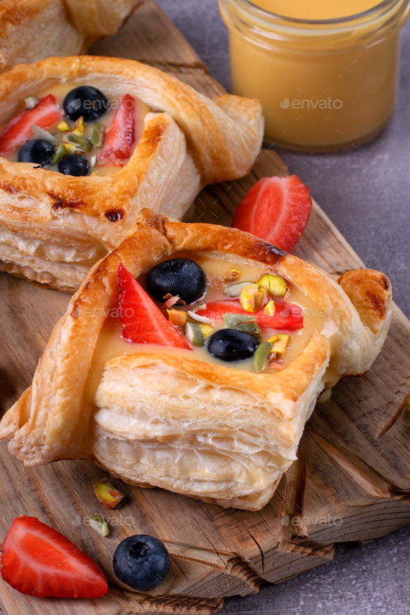 Puff pastry buns with custard, strawberry and blueberry Stock Photo by ...