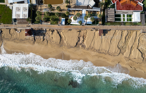 Aerial view of ocean waves breaking on a sandy beach. Beach erosion ...