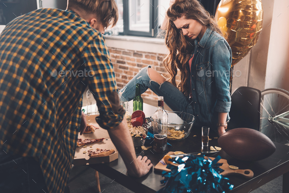 man and woman cleaning messy room after party Stock Photo by ...