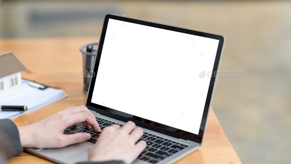 Close up. woman hand using and typing on laptop blank white screen in ...