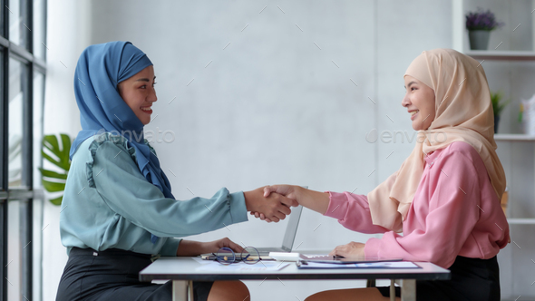 Beautiful Muslim Asian business woman shaking hands to promise to work ...
