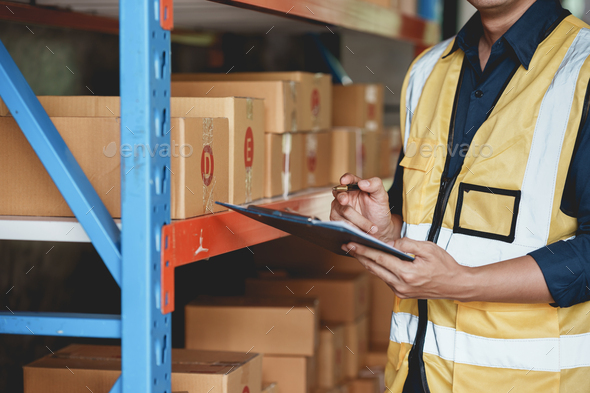 Male warehouse check worker checking and counting inventory accurately ...