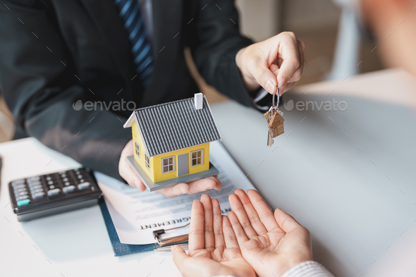 Real estate agent gives the couple the keys to the house after they ...