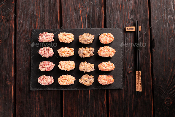 Set of Gunkan Maki Sushi with different types of fish salmon, scallop, perch, eel, shrimp and ...