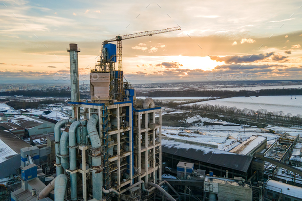 Aerial view of cement plant with high factory structure and tower crane ...