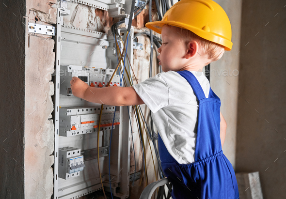 Little boy repairing electrical control panel at home. Stock Photo by ...