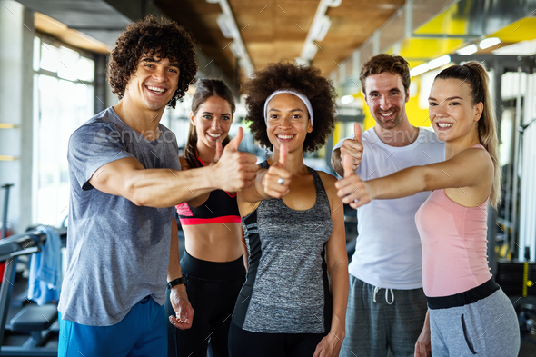 Group of fit people working out in a gym. Multiracial friends ...
