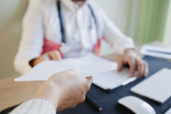 Doctor giving patient a note Stock Photo by sweet_elenia | PhotoDune
