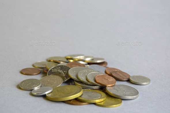 Coins of different countries and denominations on gray background. Coin ...