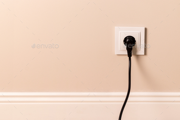 Electrical outlet with plug on beige wall Stock Photo by Bykfa | PhotoDune