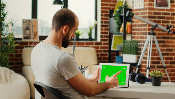 Freelancer working with isolated horizontal greenscreen display on ...