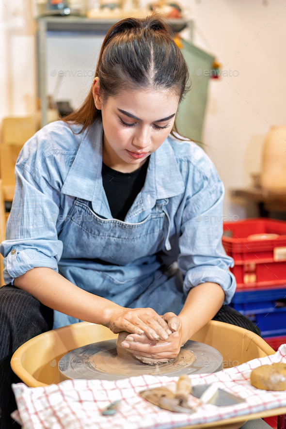 Women learn to make clay pot on potters wheel making ceramic clay ...