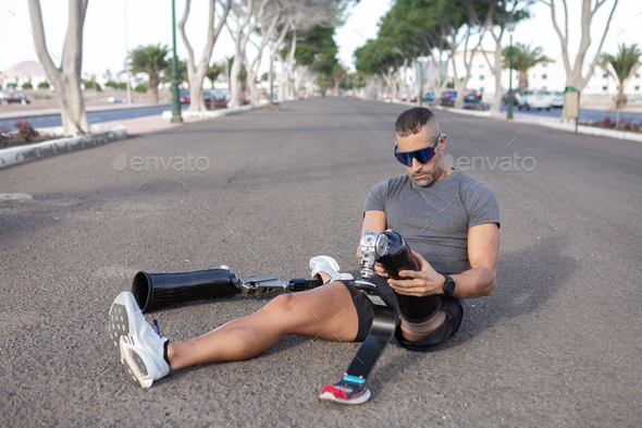 Runner with disability putting on blade leg prosthesis Stock Photo by ...