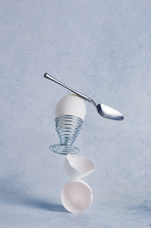 Stable balancing structure of boiled egg, egg shell and dessert spoon ...