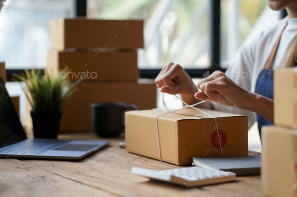 Online business owner woman check customer lists to properly pack and ...