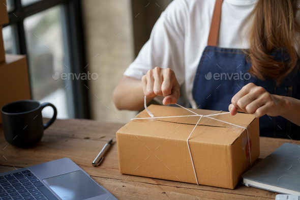 Online business owner woman check customer lists to properly pack and ...