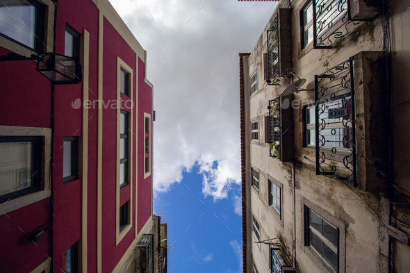 Low angle shot of narrow space between two tall buildings in the city ...
