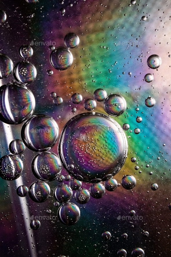 Vertical shot of soap bubbles on a colorful background with interesting ...