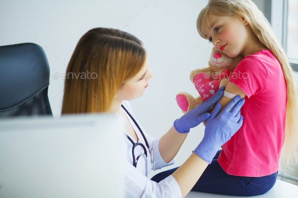 Doctor injecting vaccination in arm little child girl,healthy and ...